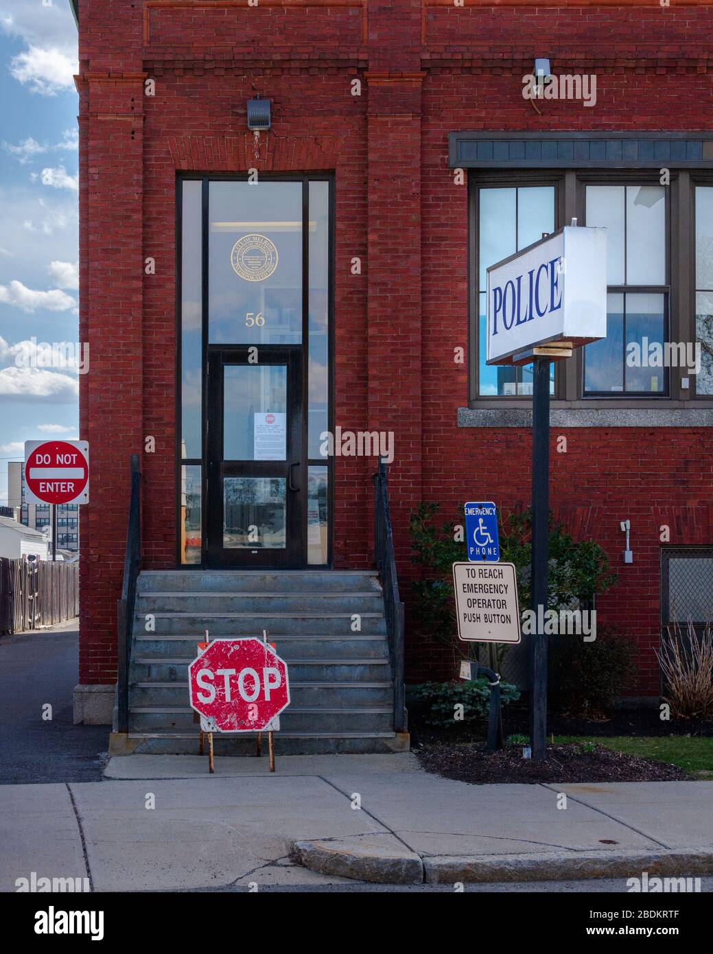 A small-town police station blocks the entrance to the building with ...