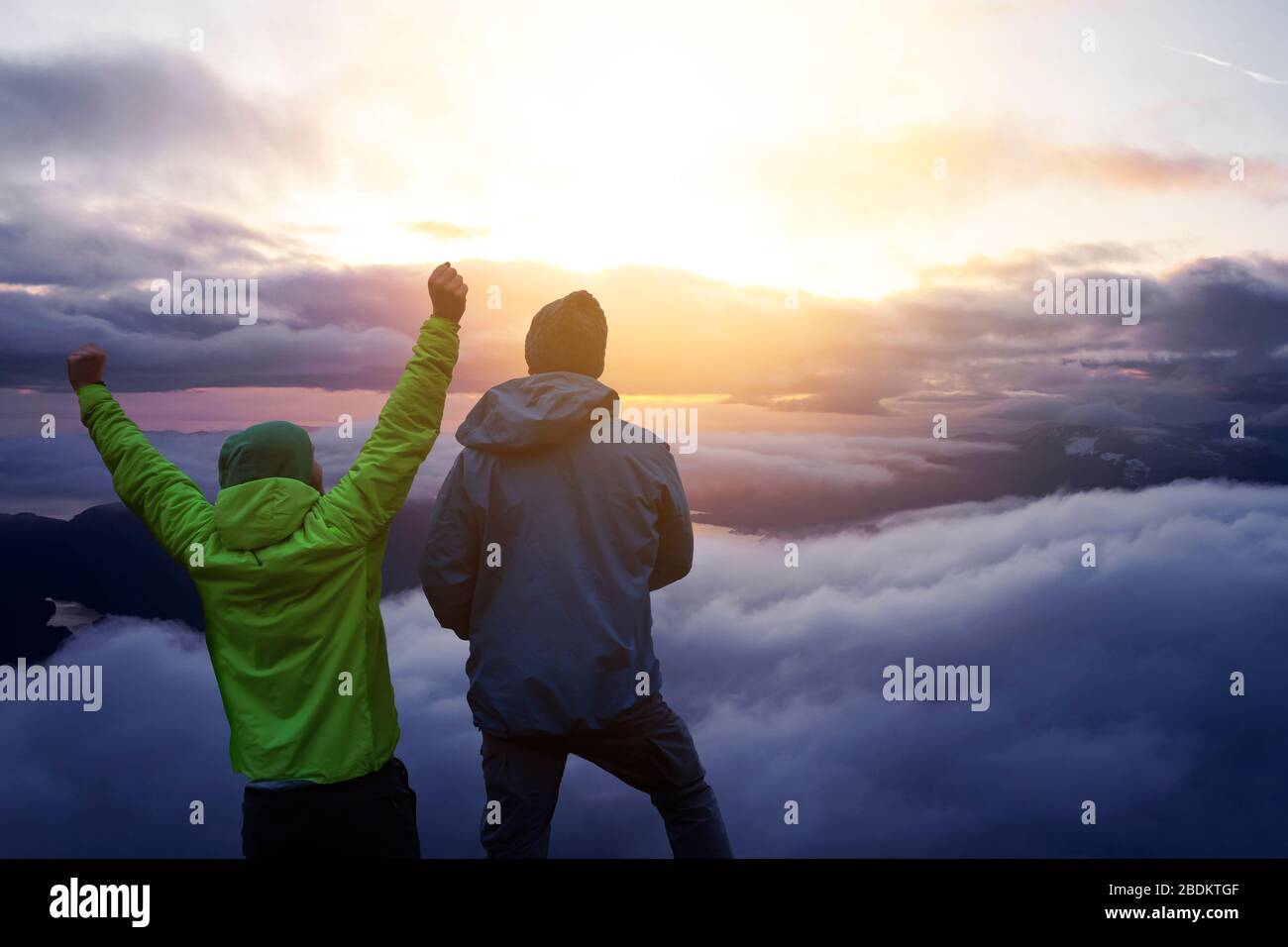 Adventurous friends on top of mountain Stock Photo - Alamy