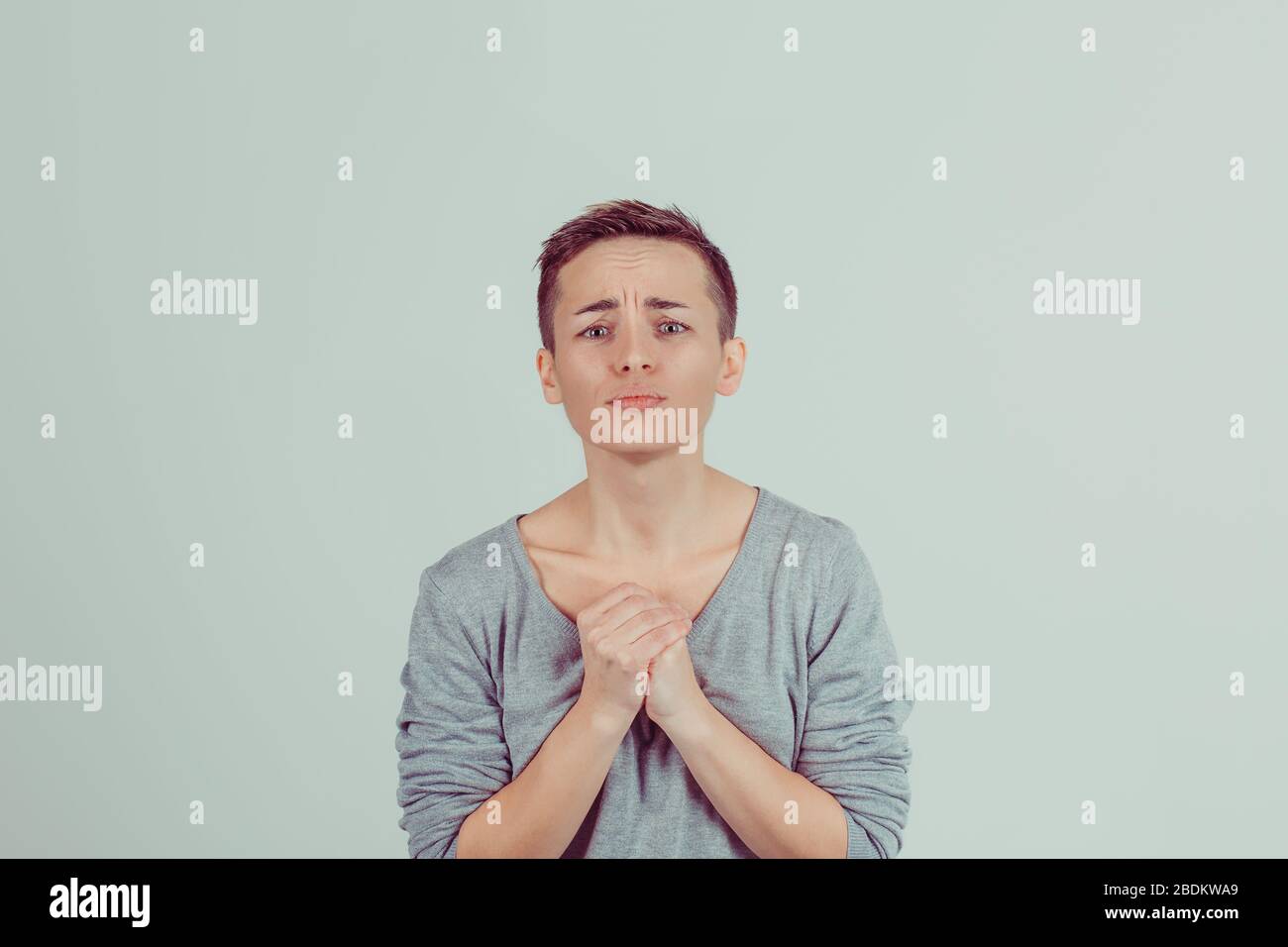 Begging. Closeup portrait sad young woman praying, hoping for the best ...