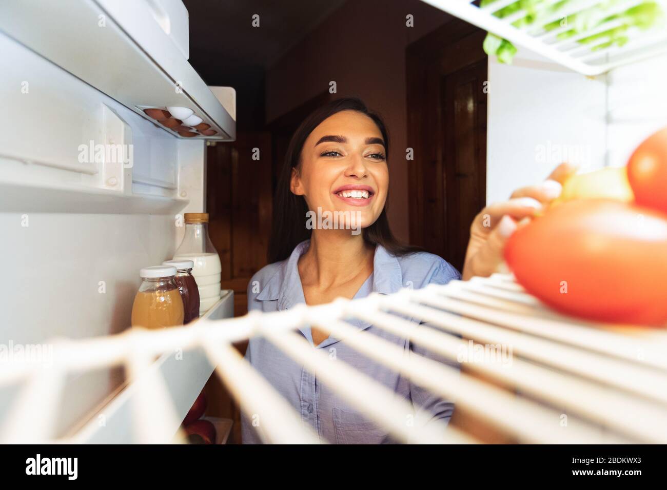 Young girl opening her fridge at home, view from inside Stock Photo - Alamy