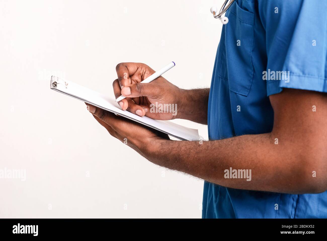 Doctor writing in patient chart hi-res stock photography and images - Alamy