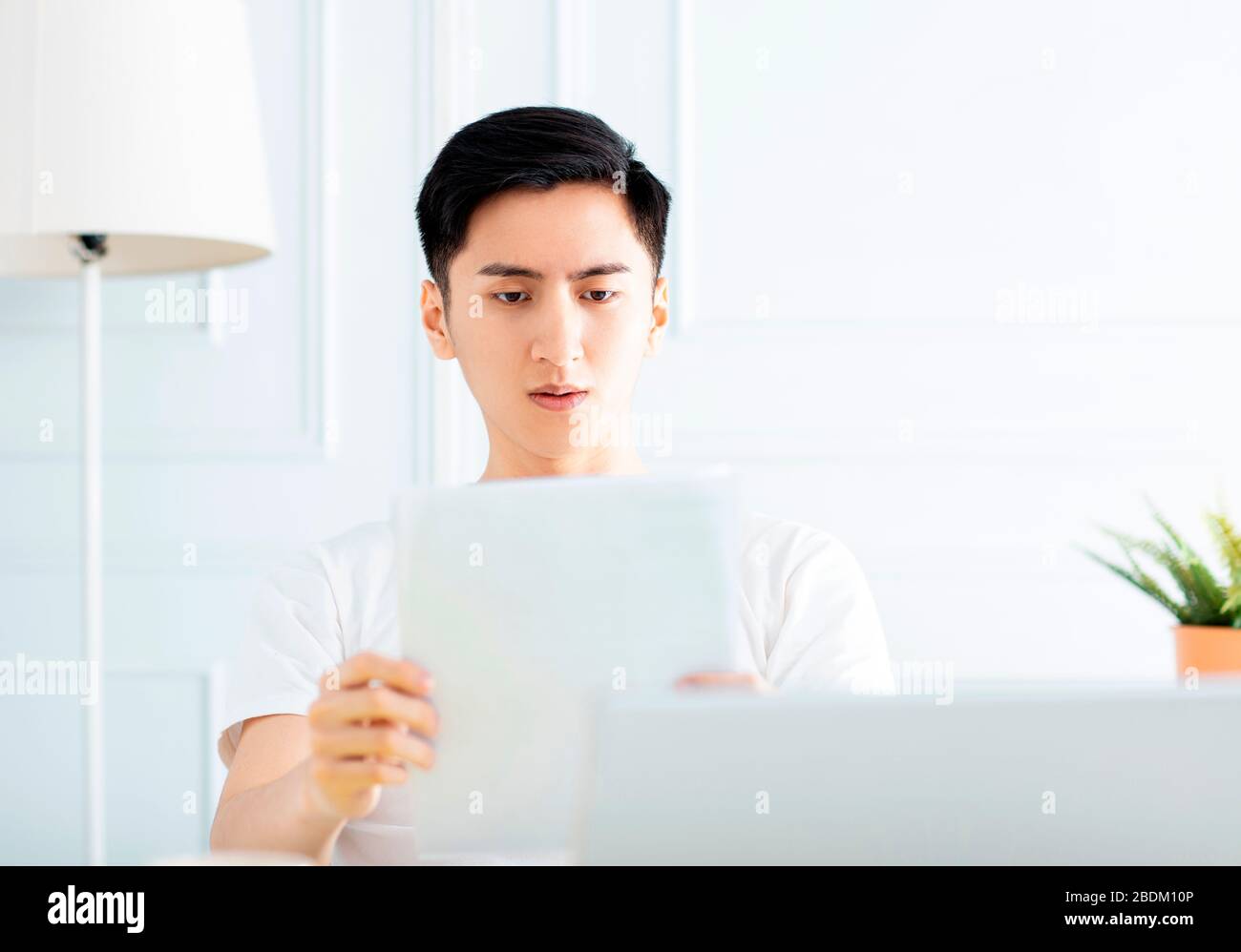 young man working at home and reading data Stock Photo - Alamy