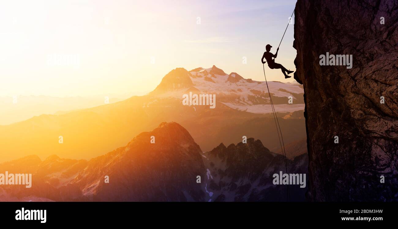 Silhouette Rappelling from Cliff Stock Photo - Alamy