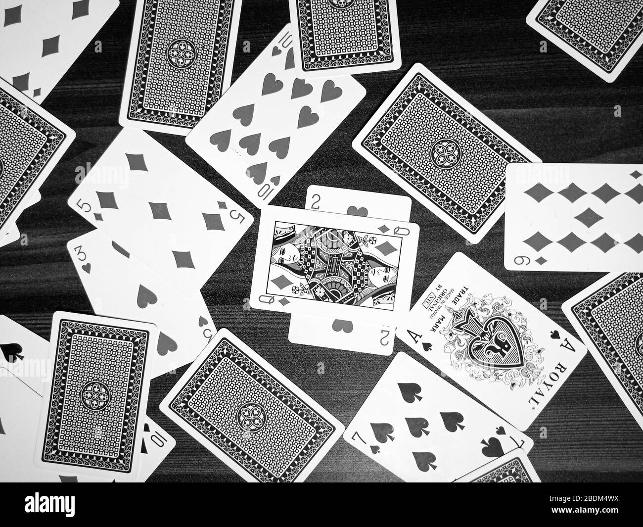 Playing cards in wooden table black and white enjoy your game Stock ...