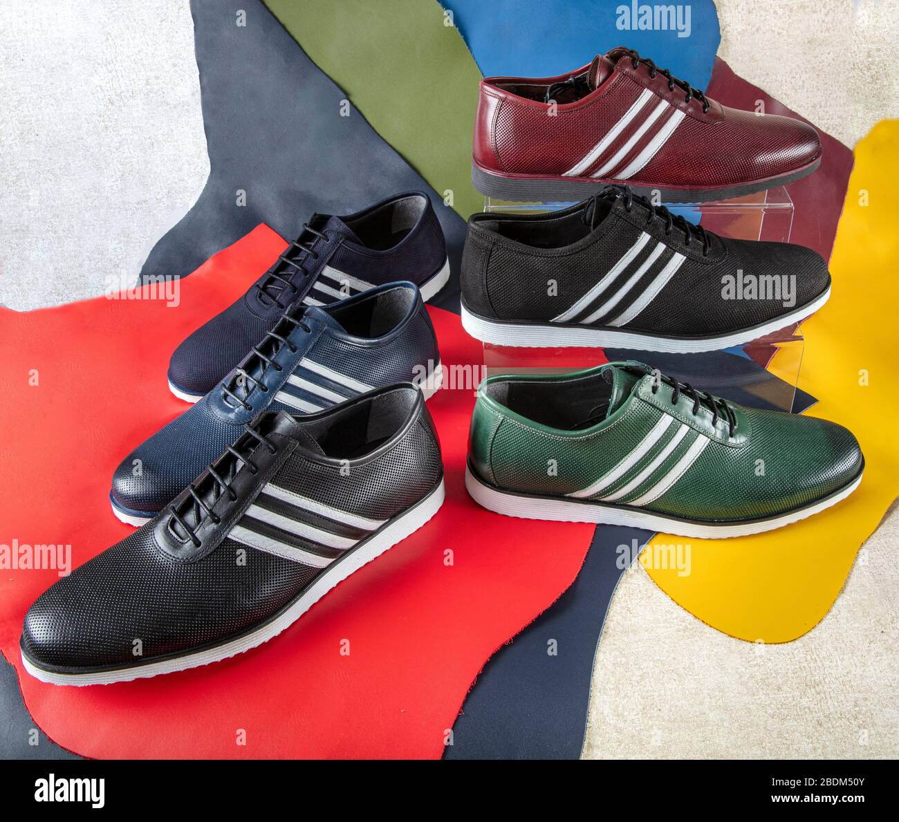 handmade leather shoes on different colored leather pieces. men fashion ...