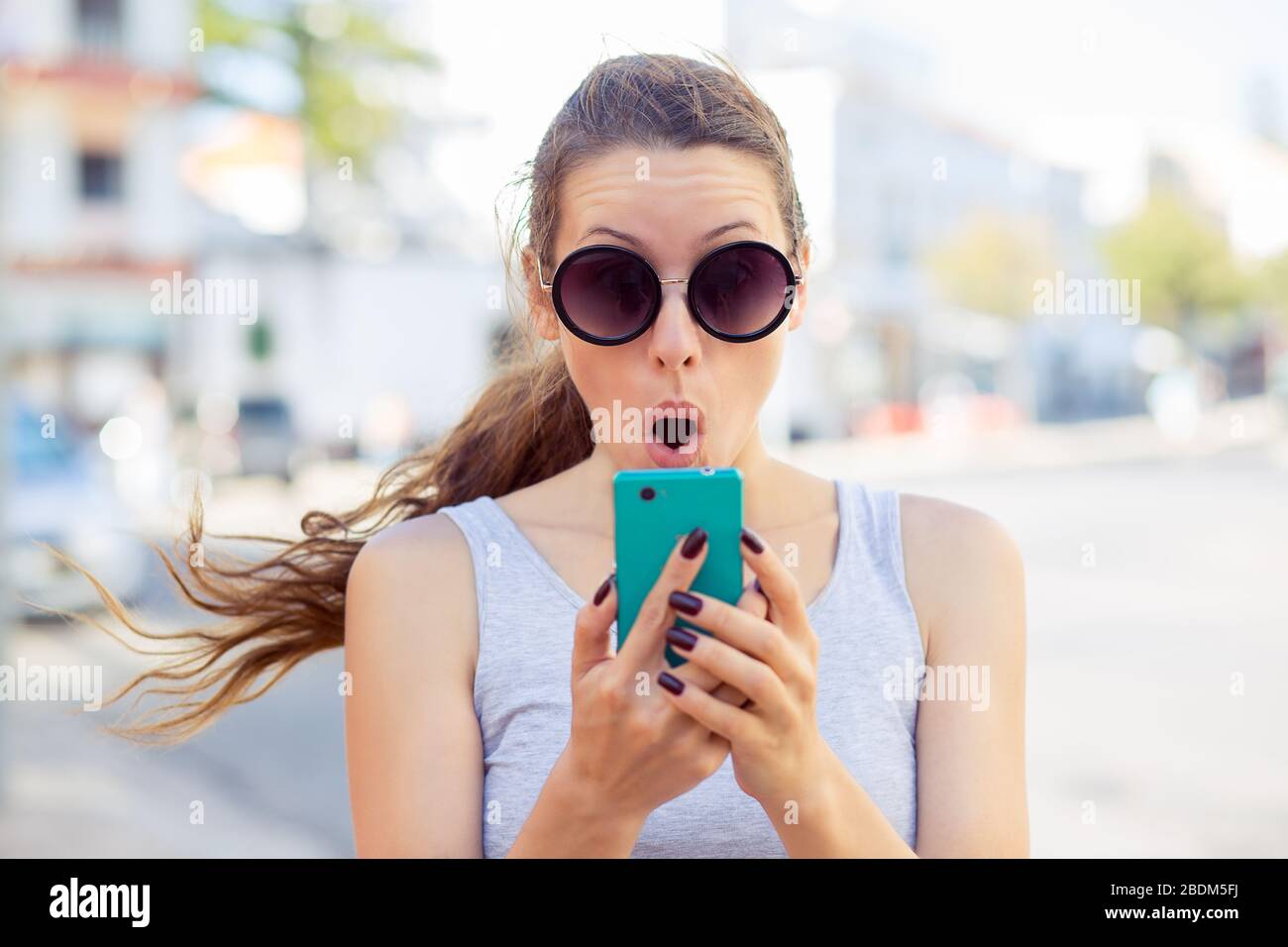 SMS. Closeup portrait funny shocked anxious scared young girl looking ...