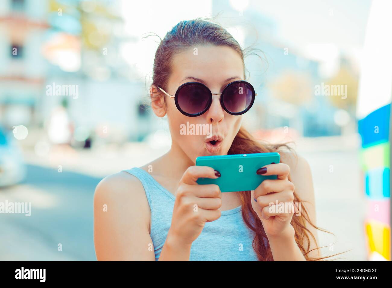 SMS. Closeup portrait funny shocked anxious scared young girl looking ... SMS. Closeup portrait funny shocked anxious scared young girl looking ...