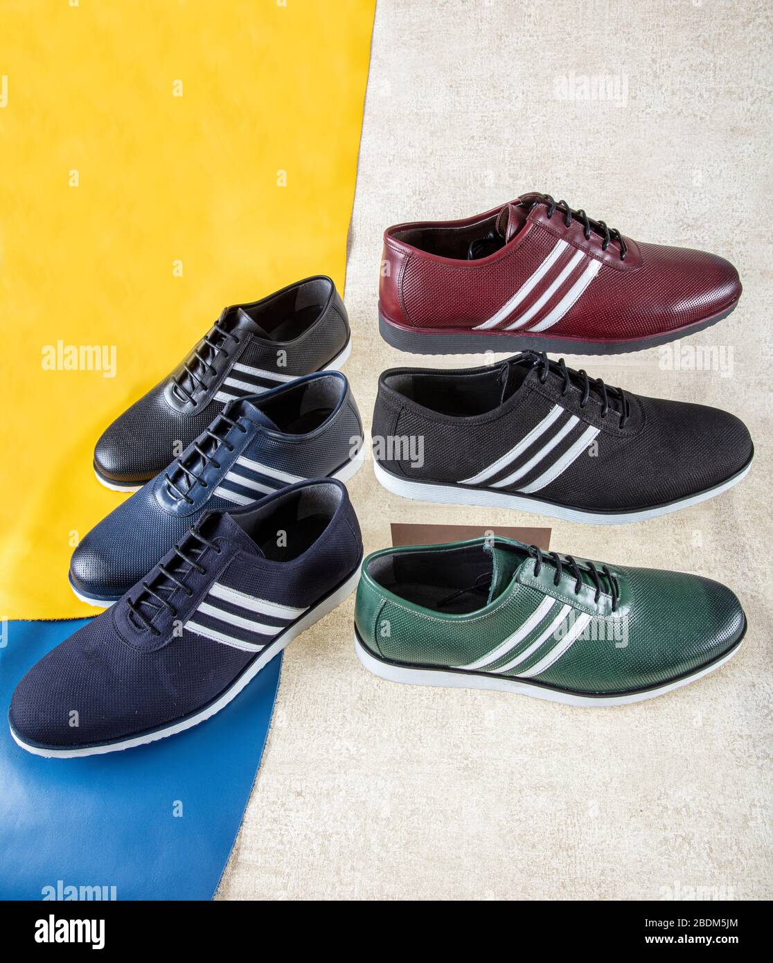 handmade leather shoes on different colored leather pieces. men fashion ...