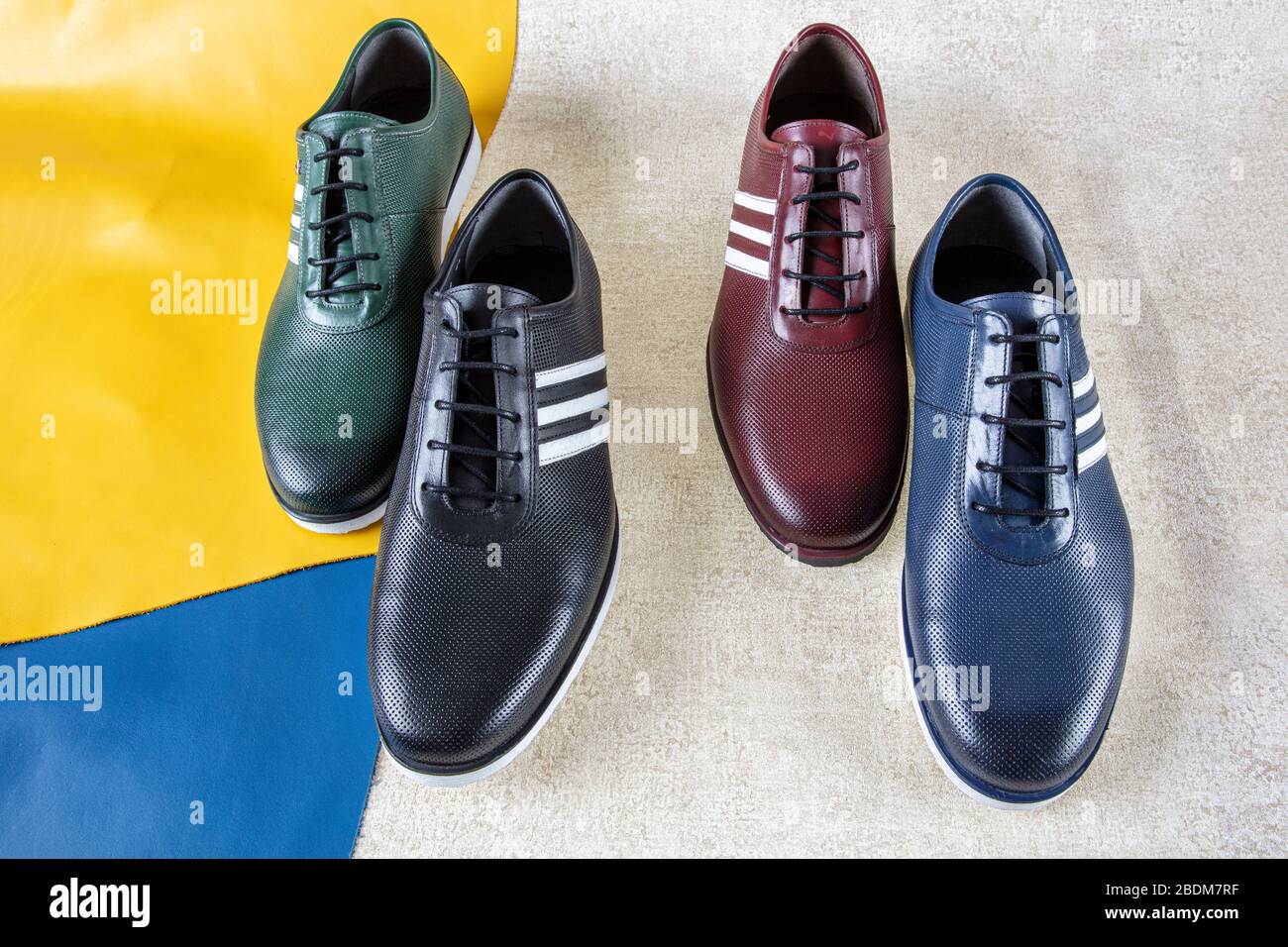 handmade leather shoes on different colored leather pieces. men fashion ...