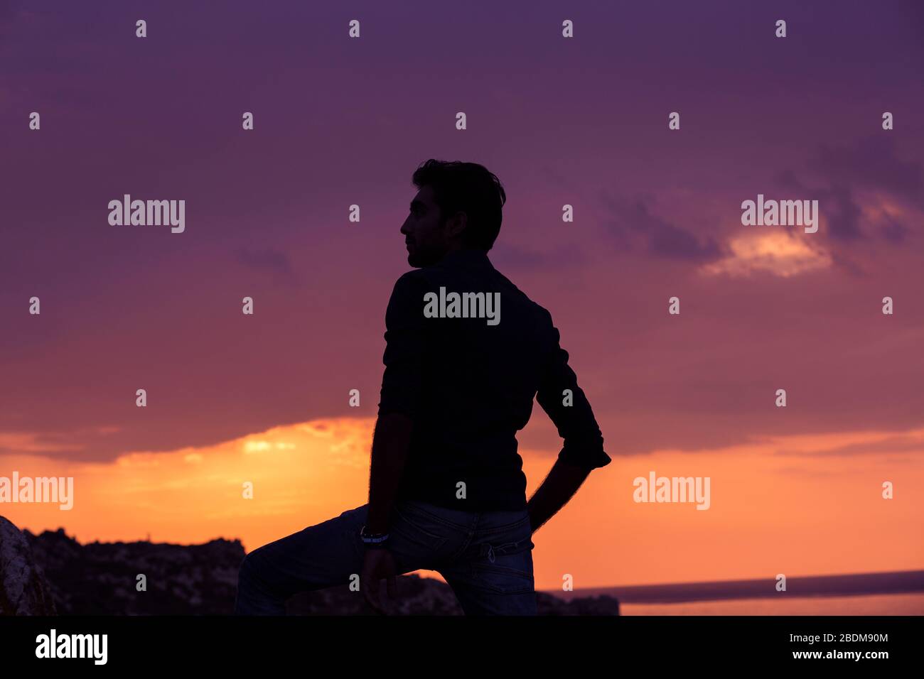man standing thinking back light sunset lighting side view summer ...