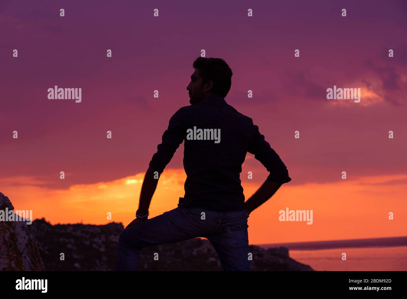 man standing thinking back light sunset lighting side view profile ...