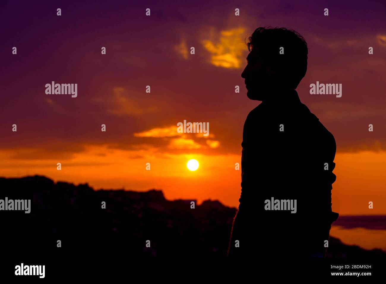 man standing thinking back light sunset lighting side view summer ...