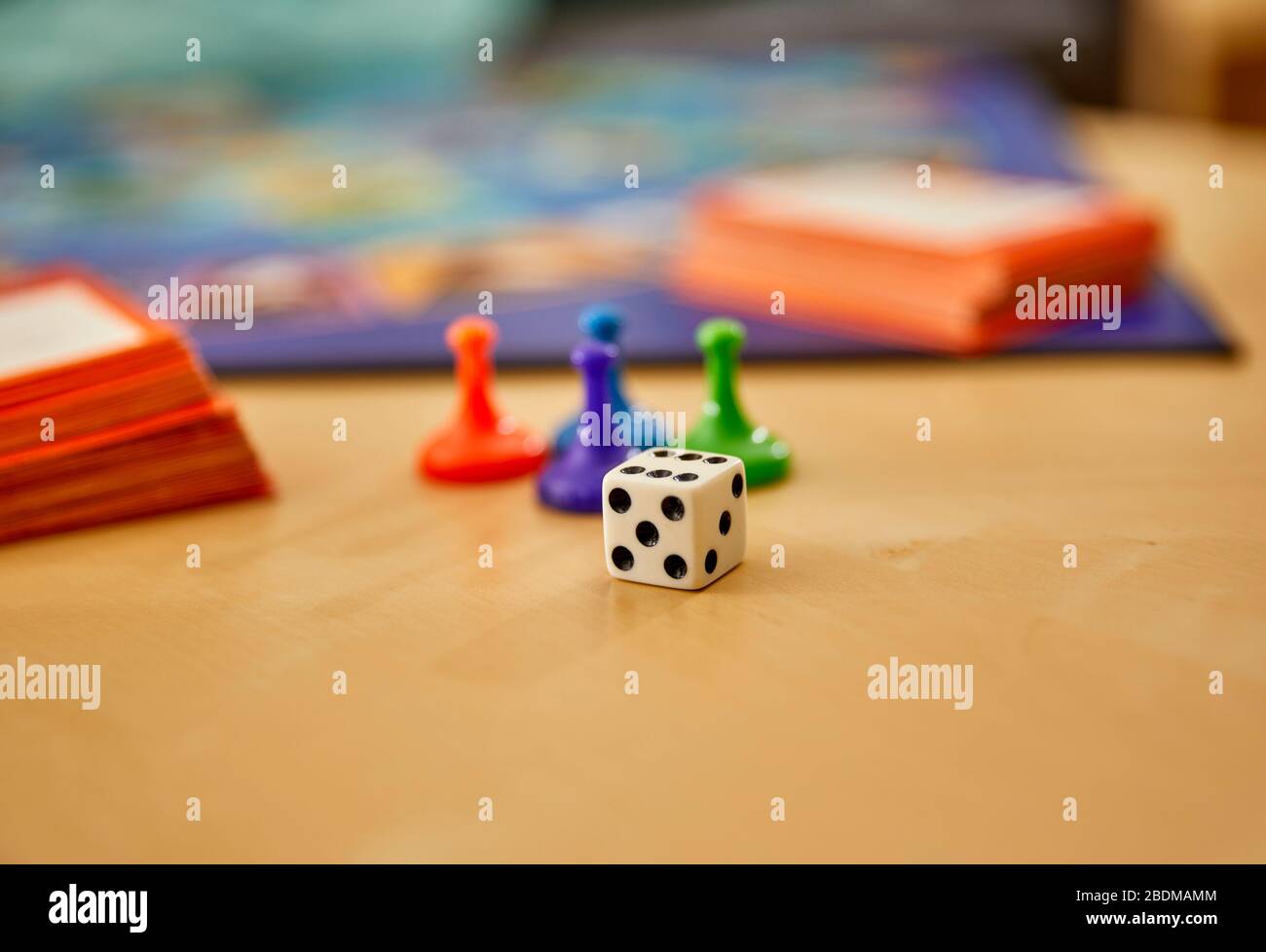 Close up of board game pieces with dice and cards with shallow depth of ...