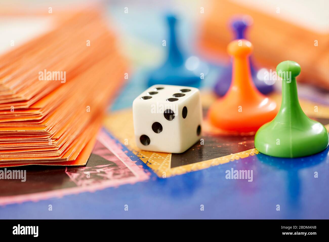 Close up of board game pieces with dice and cards with shallow depth of ...
