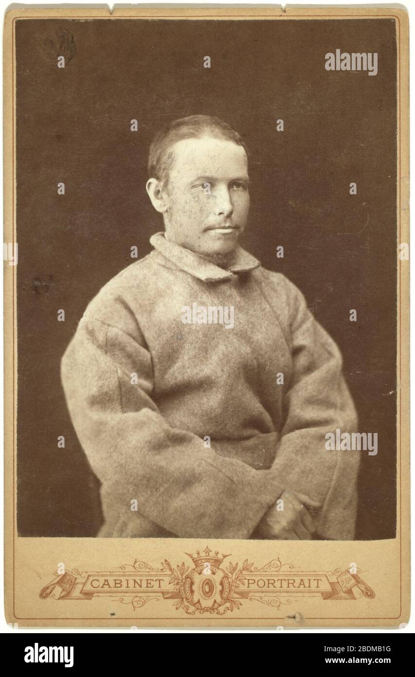 Half-length portrait of a man in convict coat, seated, facing right ...