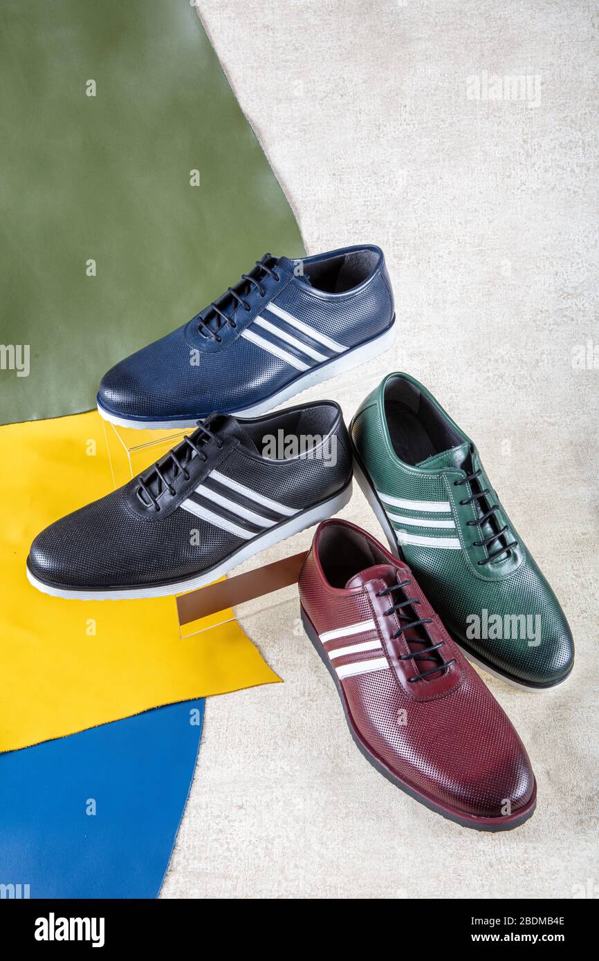 handmade leather shoes on different colored leather pieces. men fashion ...
