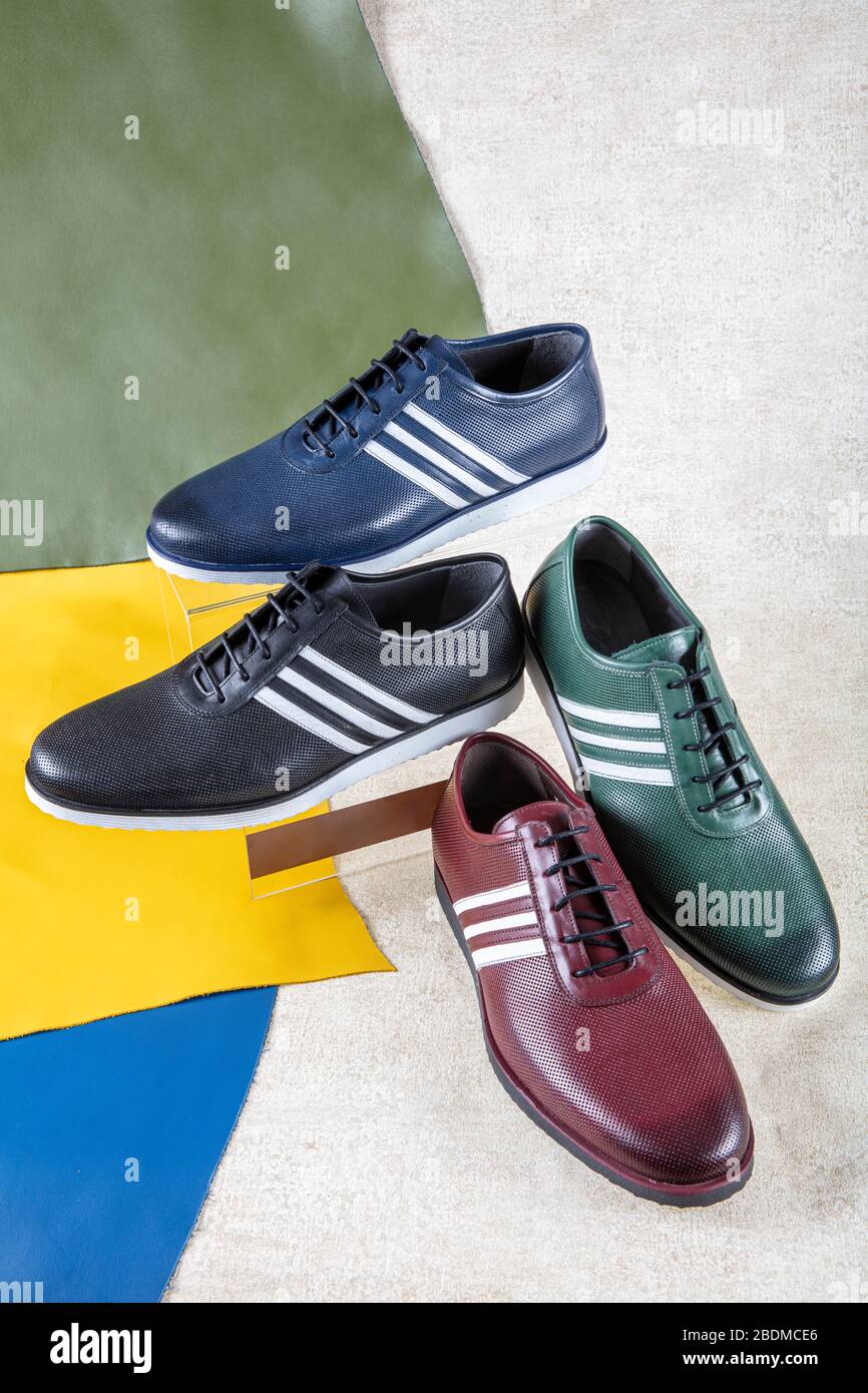 handmade leather shoes on different colored leather pieces. men fashion ...