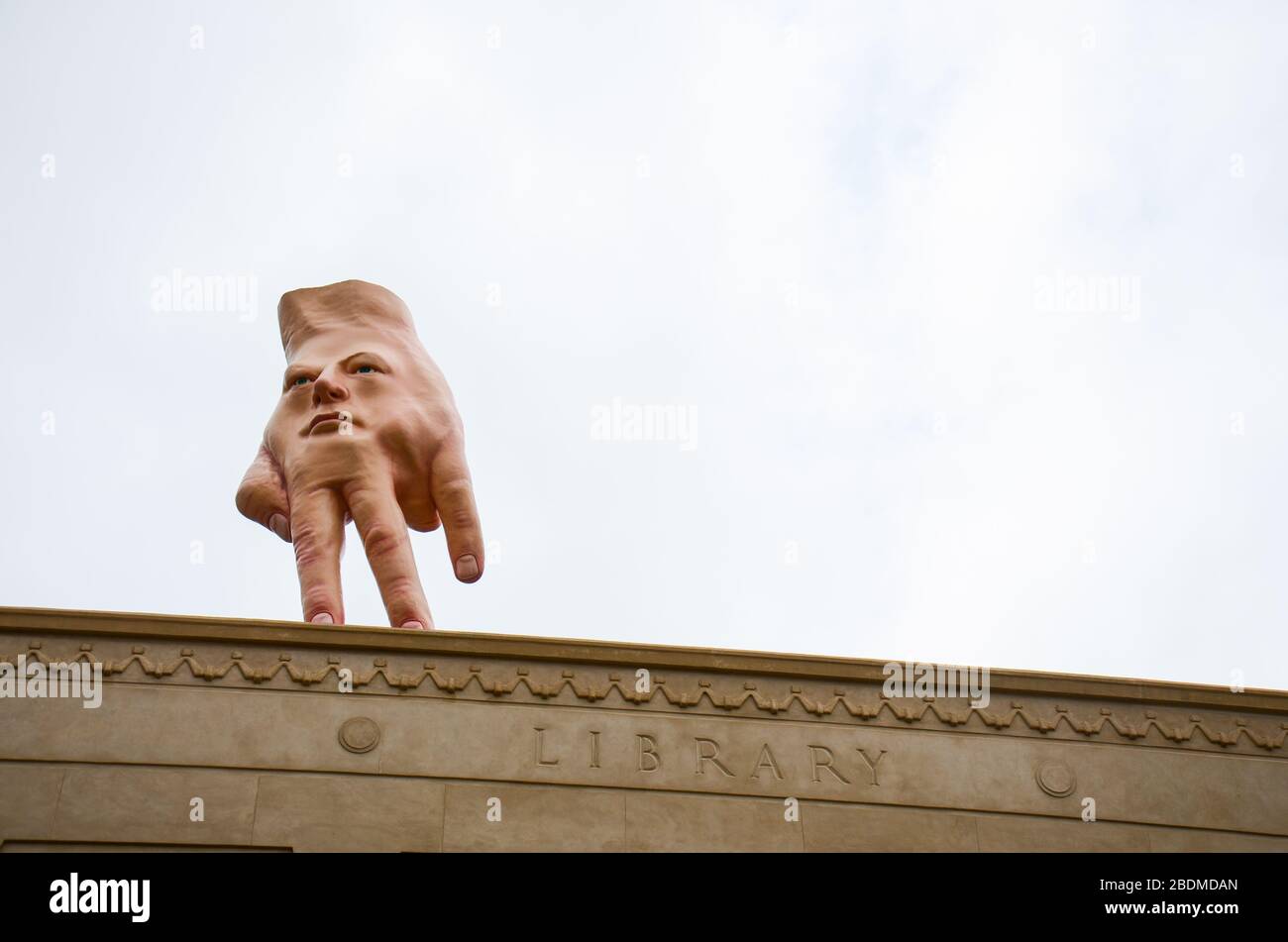 WELLINGTON, NEW ZEALAND - April 4, 2020: Hand with face on top of city ...