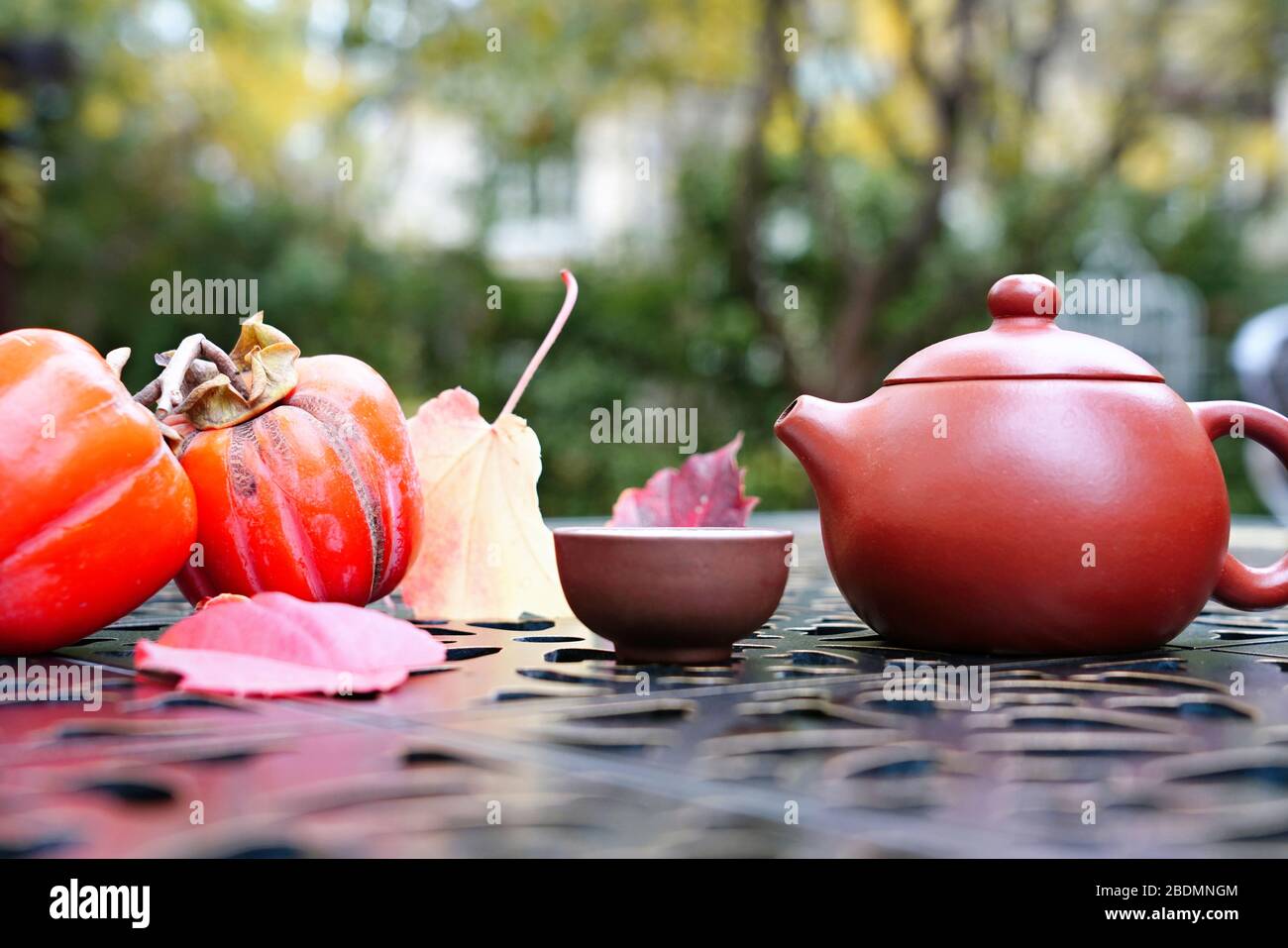 Persimmon and tea set Stock Photo - Alamy