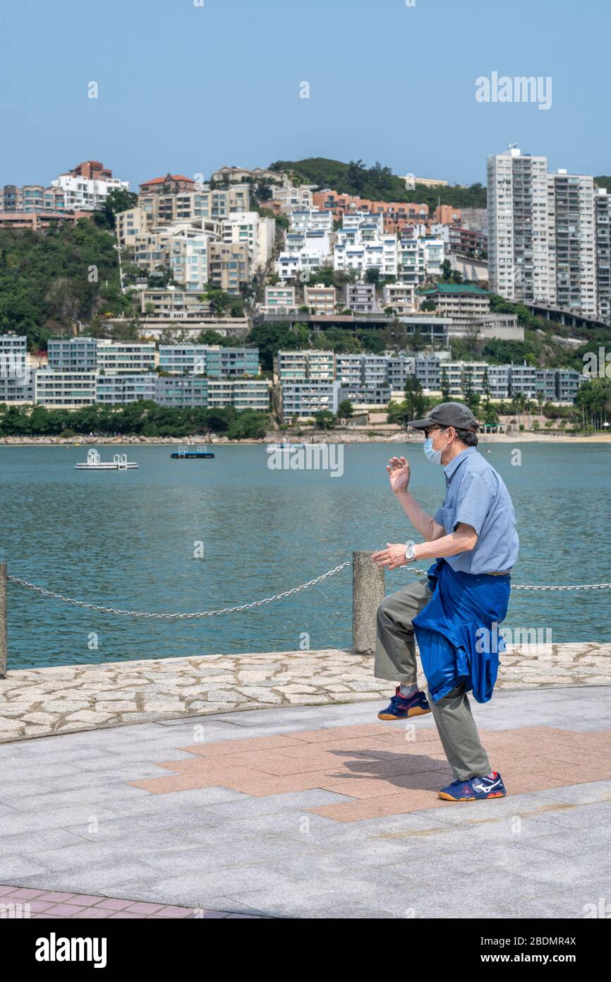 A man wears a mask while practicing Tai Chi outdoors in Hong Kong Stock ...