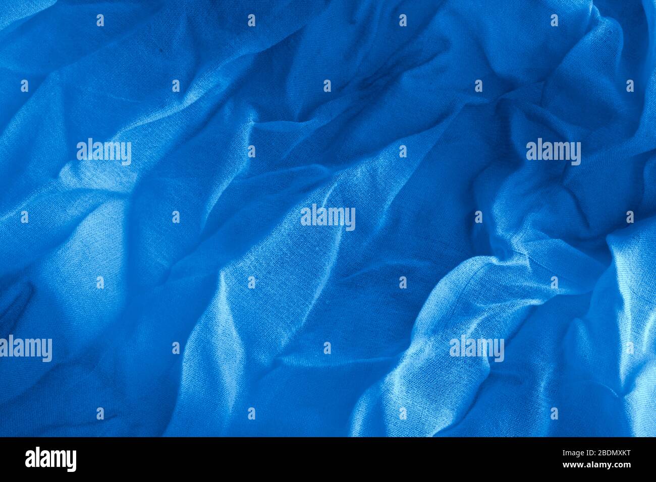 Texture of classic blue Wrinkled Fabric. Trendy color of clothes. Close ...