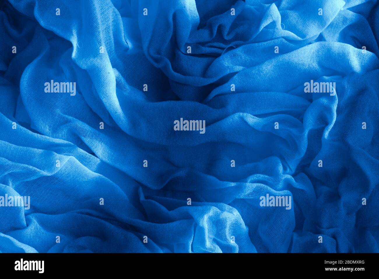 Texture of classic blue Wrinkled Fabric. Trendy color of clothes. Close ...