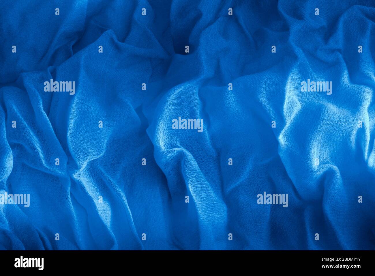 Texture of classic blue Wrinkled Fabric. Trendy color of clothes. Close ...