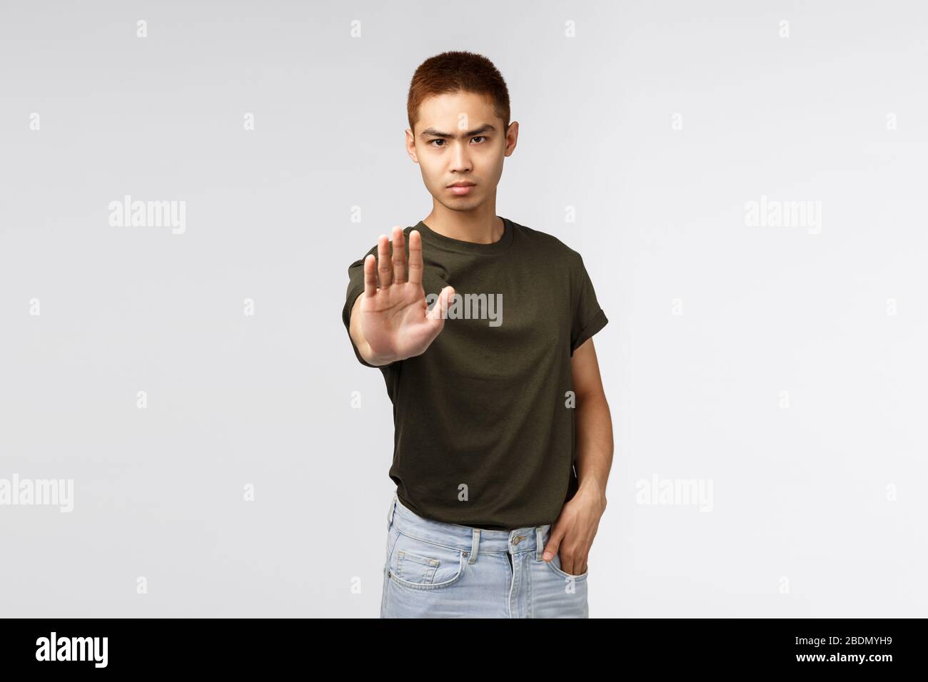 Stop right there. Serious-looking asian man frowning angry, show stop ...