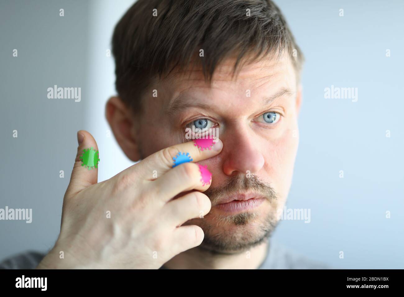 Man scratches his face with a dirty hand near his eye Stock Photo - Alamy