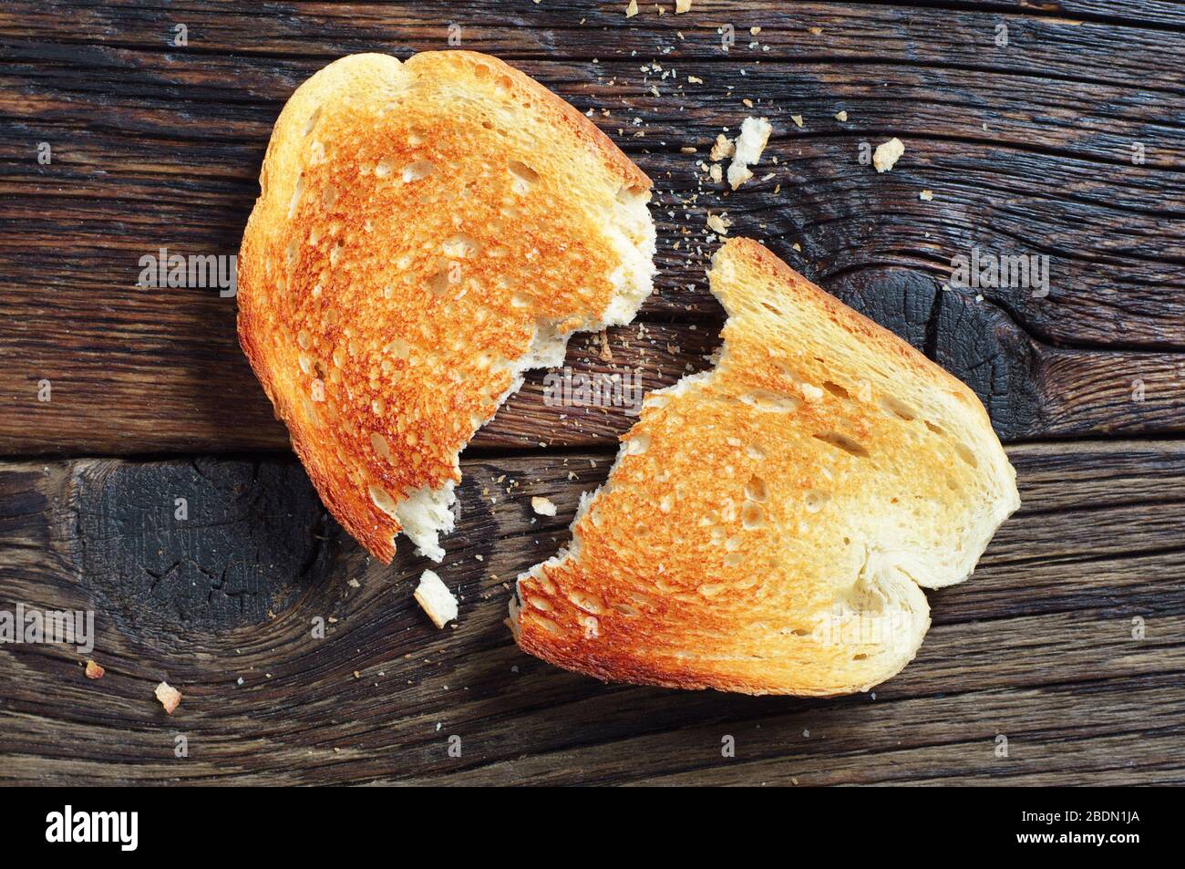 Ripped toasted bread on dark wooden table, top view Stock Photo - Alamy
