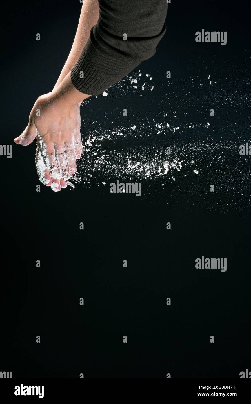 hand of woman cook in kitchen pouring white dust flour flour table for ...