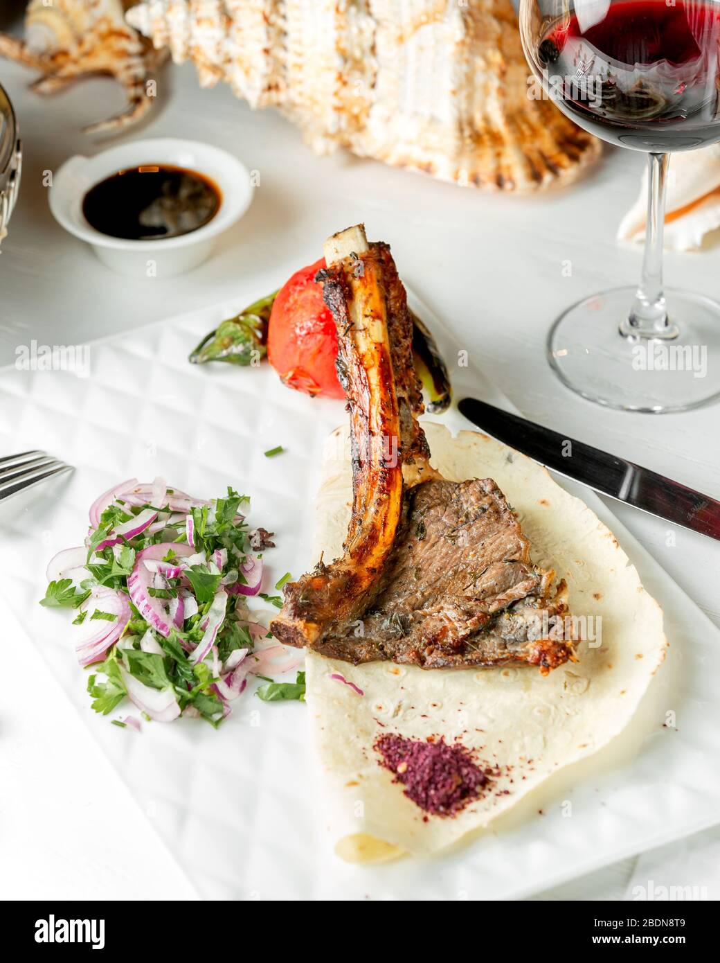 rib kebab with onion and tomato on the grill Stock Photo - Alamy