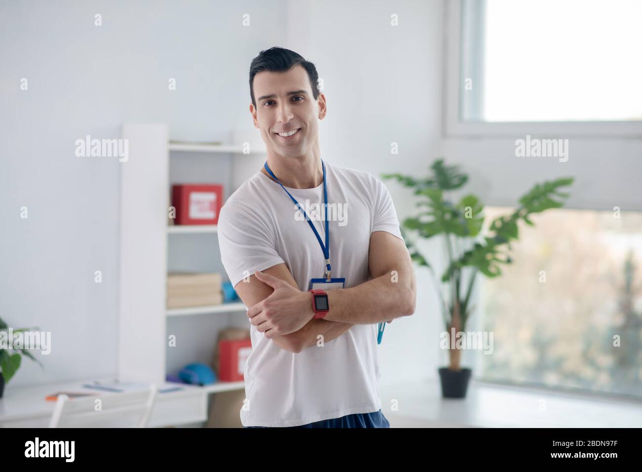 Positive joyful man standing in the room Stock Photo - Alamy