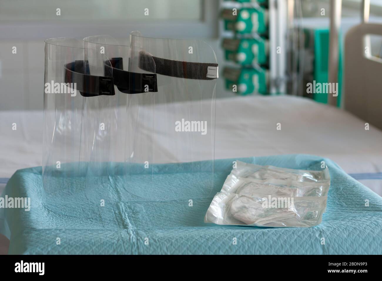 Three plastic protective shields and three respirators ffp2 on table in ...