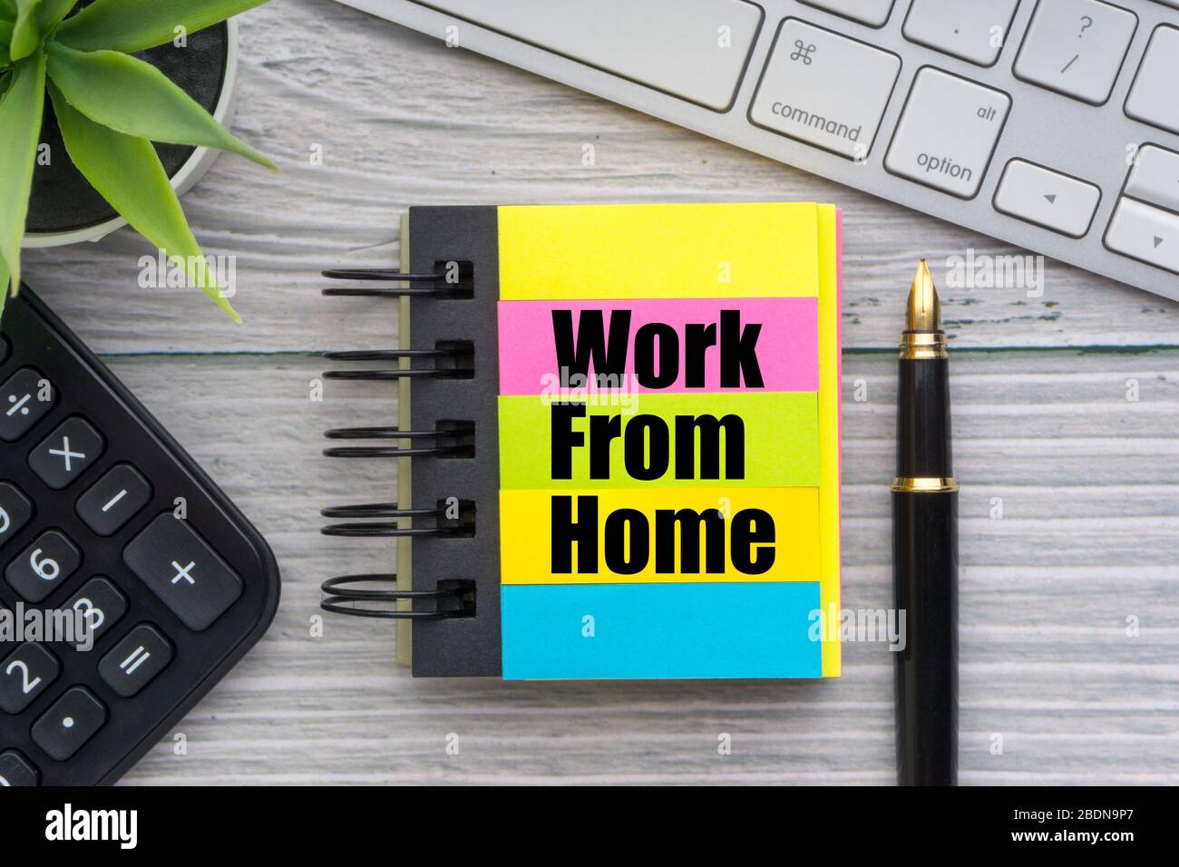 WORK FROM HOME text with decorative flower, calculator, fountain pen ...