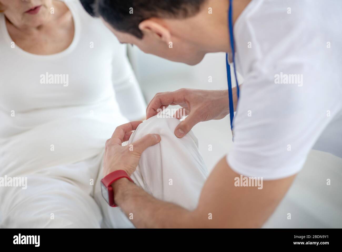 Skilled experienced therapist fixing the joint injury Stock Photo - Alamy