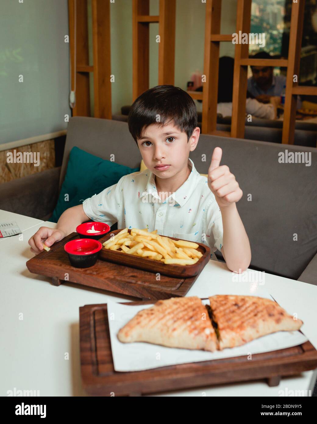 boy eats french fries with ketchup Stock Photo - Alamy