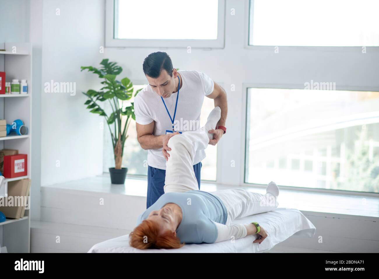 Smart skilled male therapist doing his work Stock Photo - Alamy