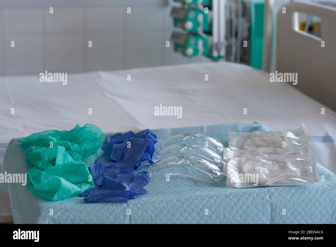 Three caps, three pairs of gloves, three plastic protective eyeglasses ...