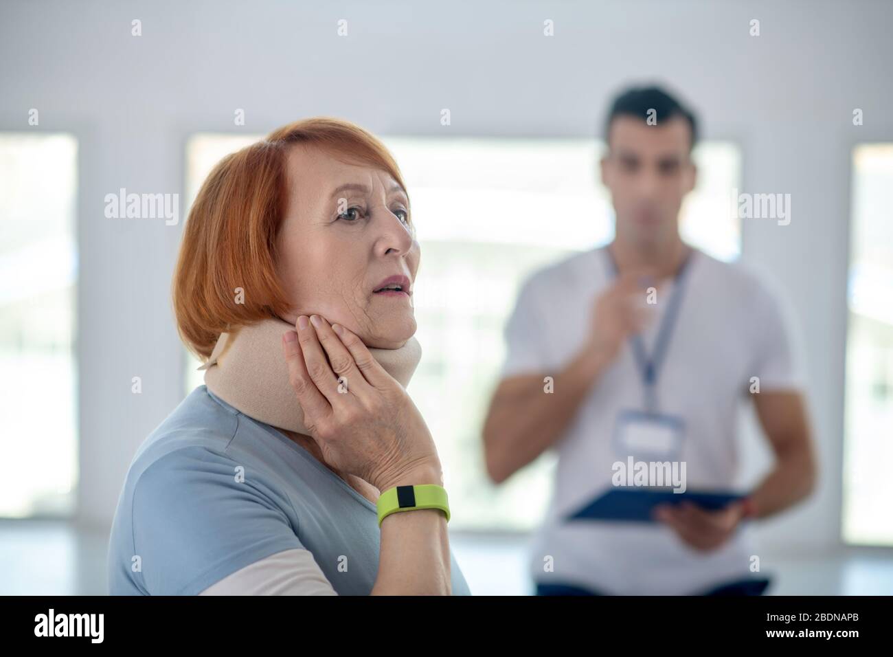 Good looking senior woman having a neck collar on her Stock Photo - Alamy