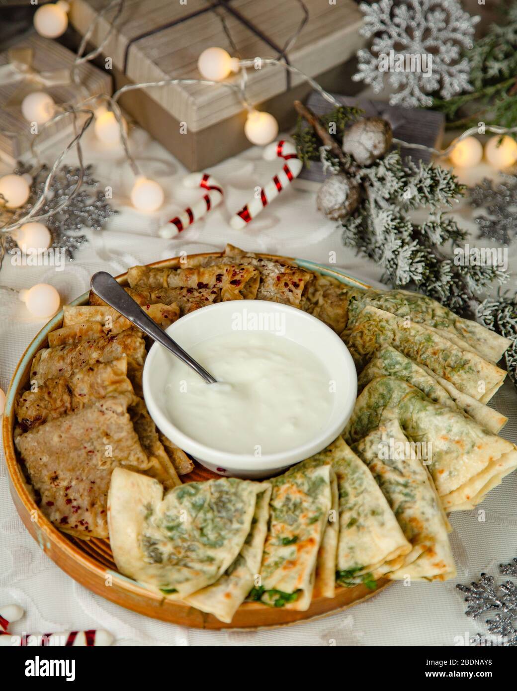 platter of gutab stuffed flatbreads with herbs and meat fillings served ...