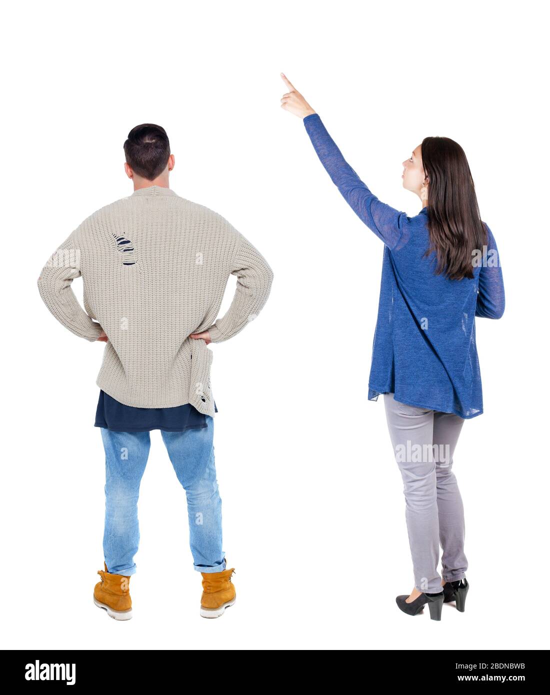 Back view of couple in sweater pointing. Rear view people collection ...