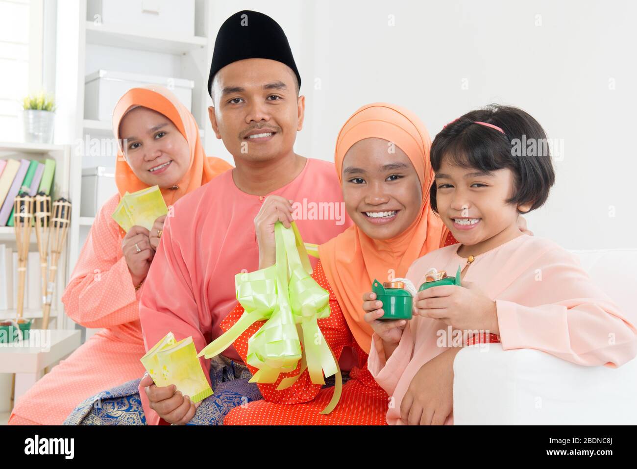 Happy Malay family portrait in traditional clothing during Hari Raya ...
