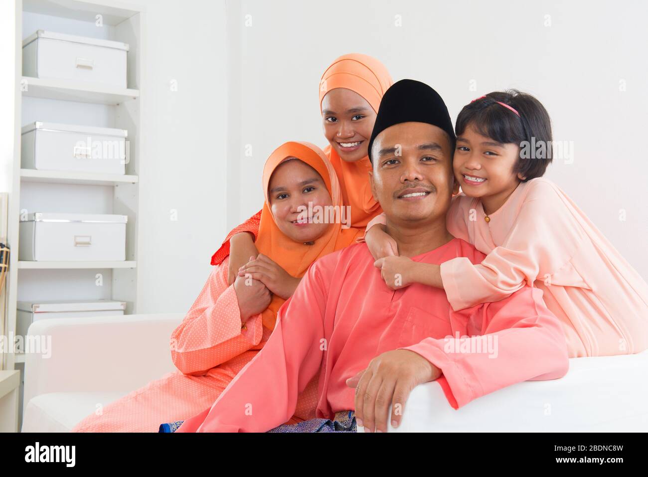 Happy Malay family portrait in traditional clothing during Hari Raya ...