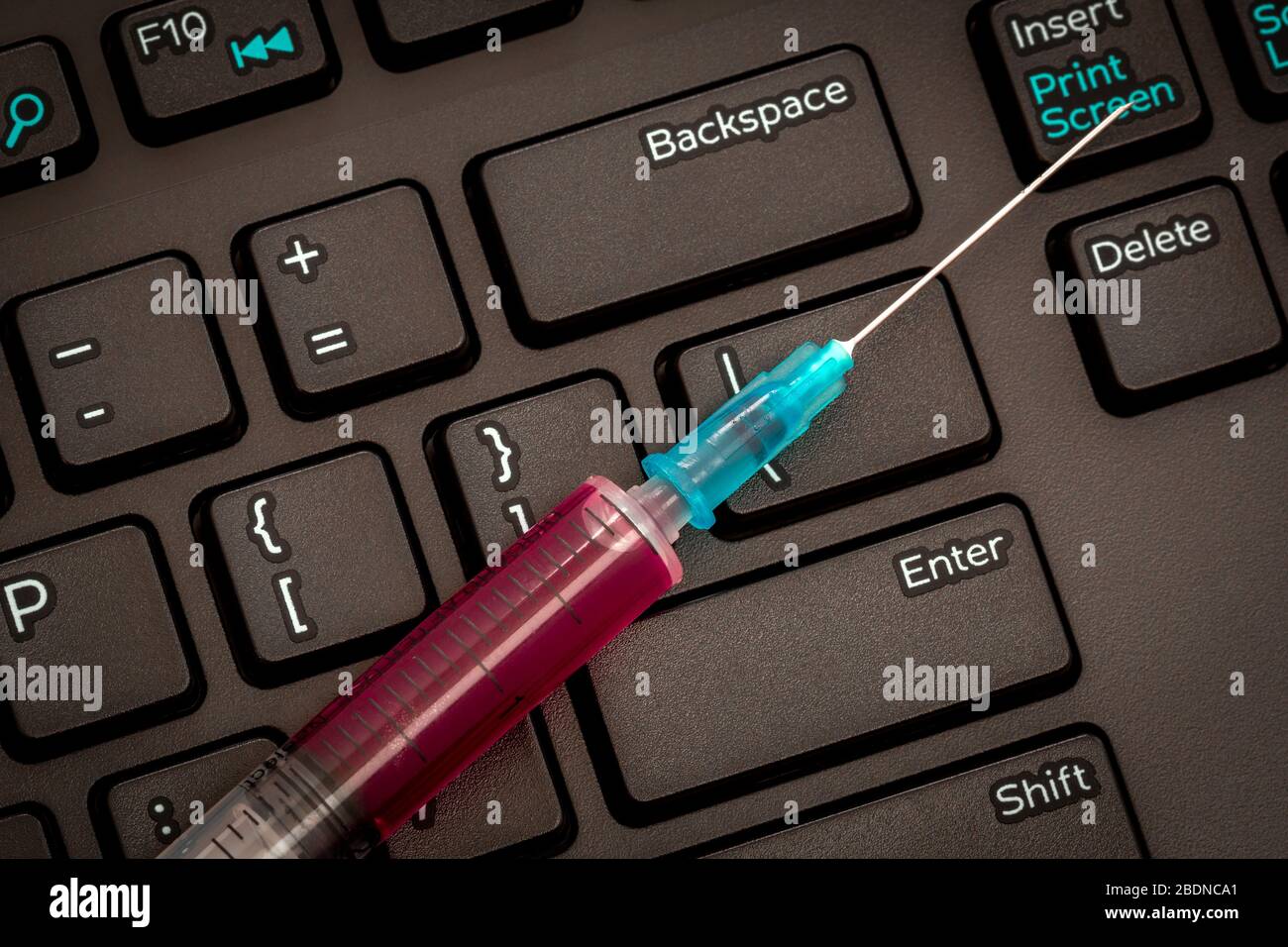 Black keyboard and syringe.Computer virus protection. The concept of ...