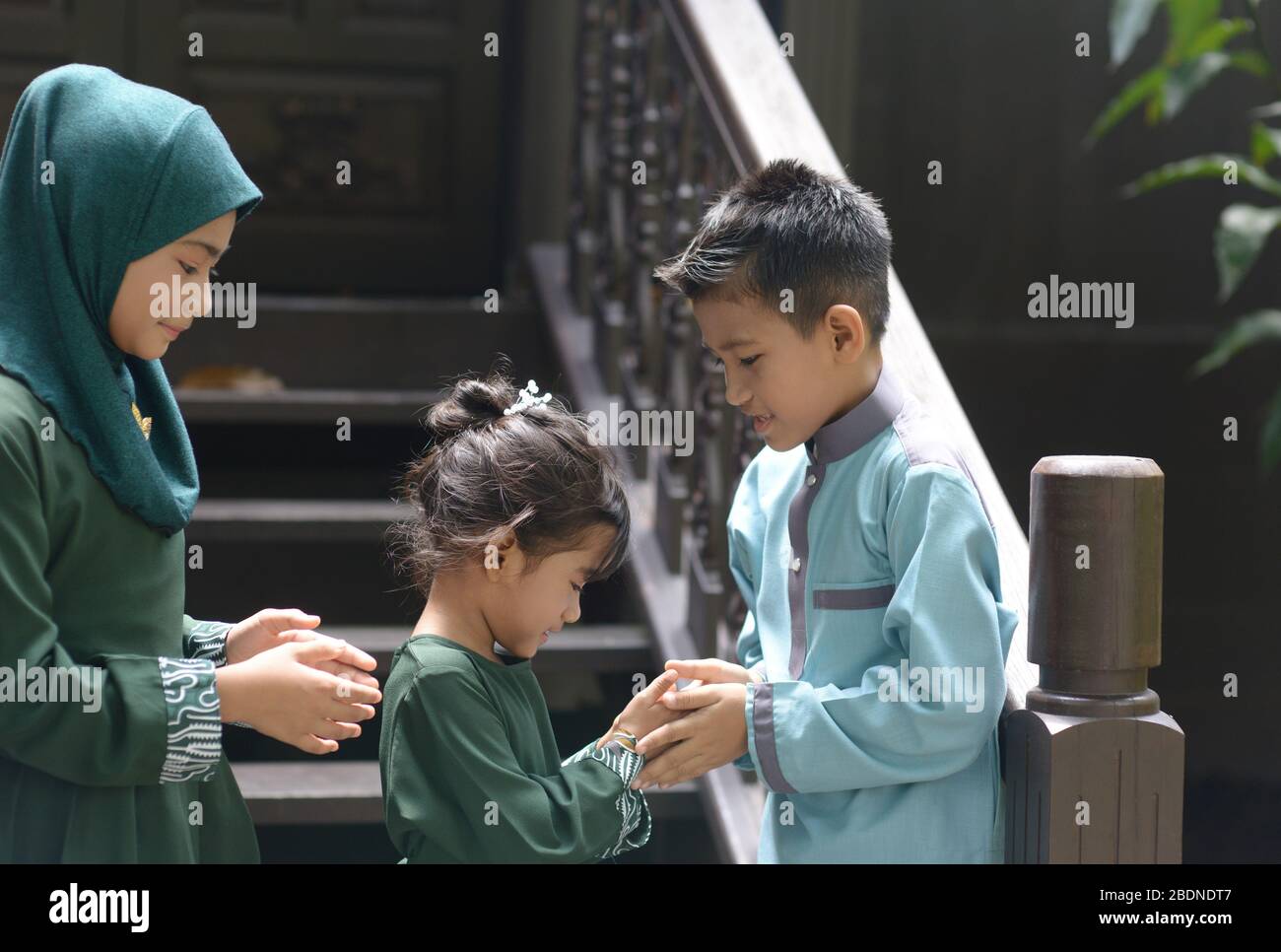 Muslim children greeting, Hari Raya Eid Al-Fitr concept Stock Photo - Alamy