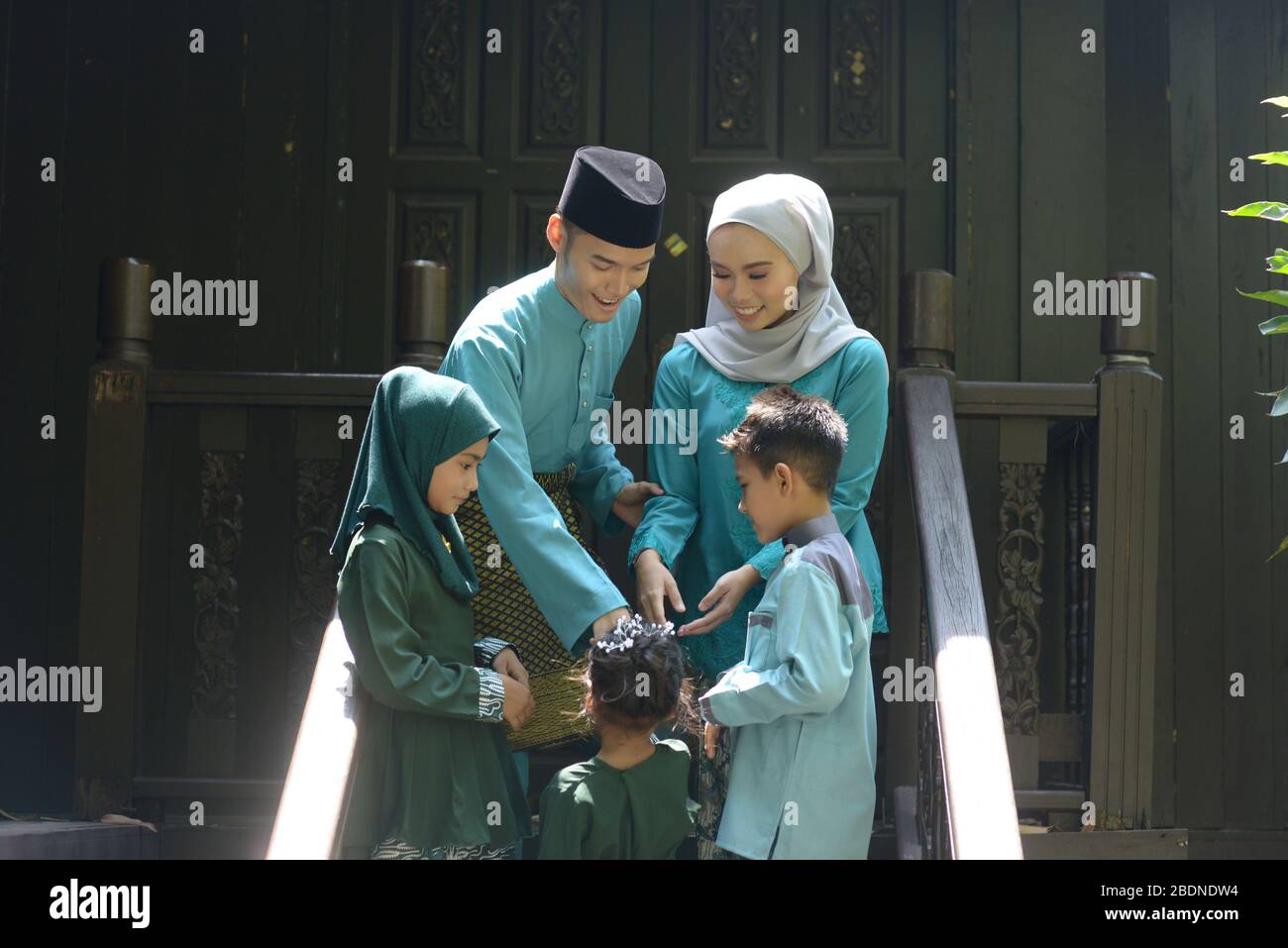 Muslim family greeting, Hari Raya Eid Al-Fitr concept Stock Photo - Alamy