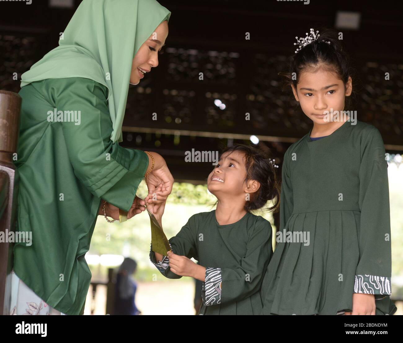 Muslim family greeting, Hari Raya Eid Al-Fitr concept Stock Photo - Alamy