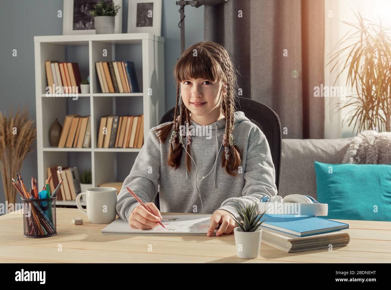 Studying girl siting at desk Stock Photo - Alamy