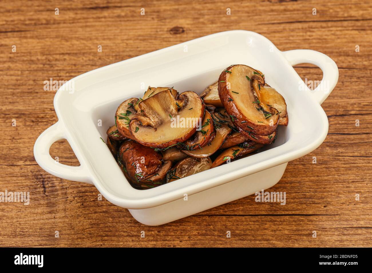 Roasted champignon with herbs and spices in the bowl Stock Photo - Alamy